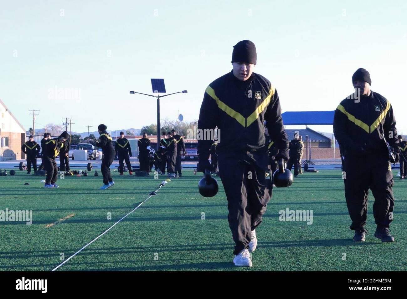 A Trooper carries two 40 pound kettlebells to the end of the 25 meter ...