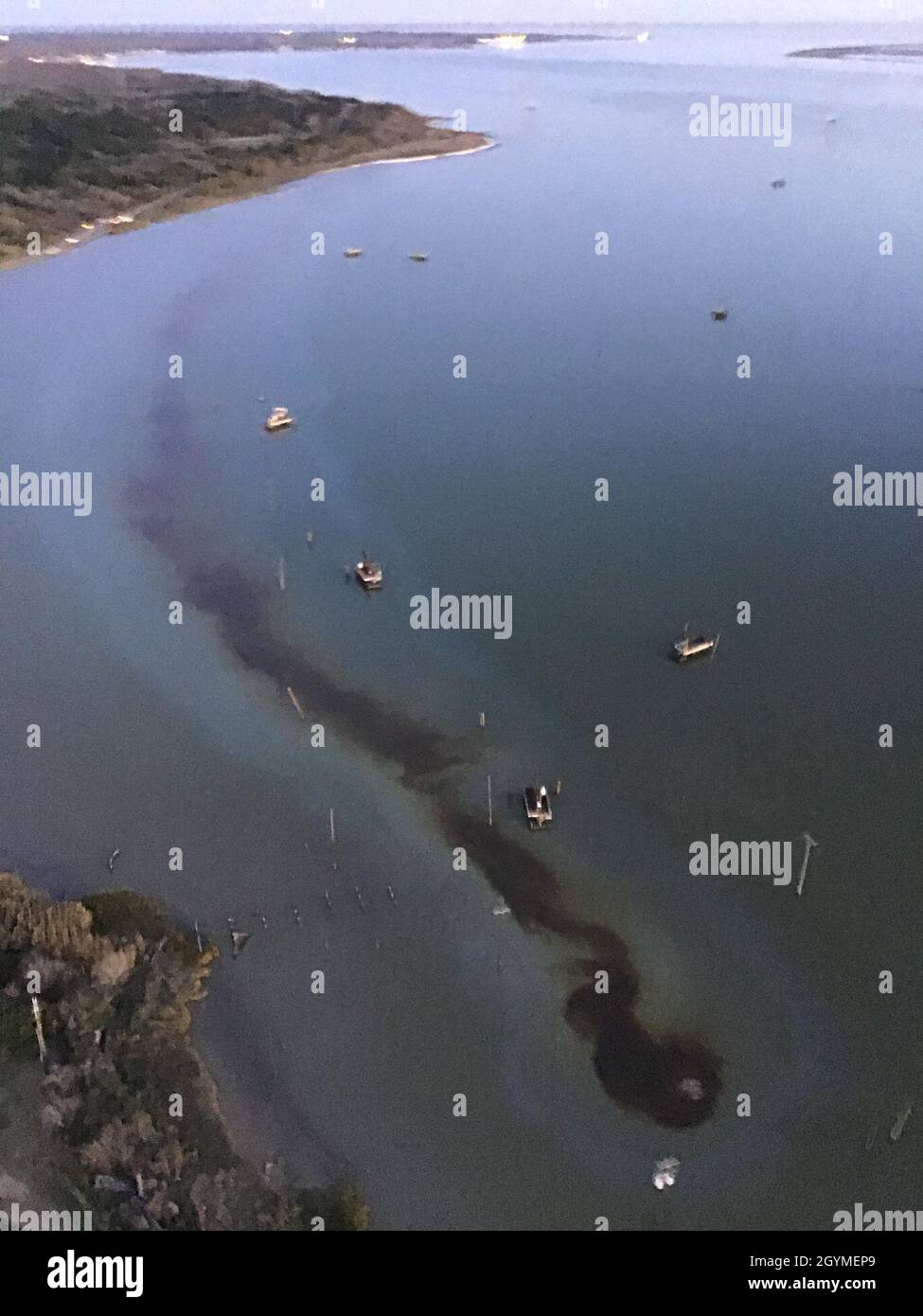 Approximately 630 gallons of crude oil floats in Tabbs Bay near Baytown ...