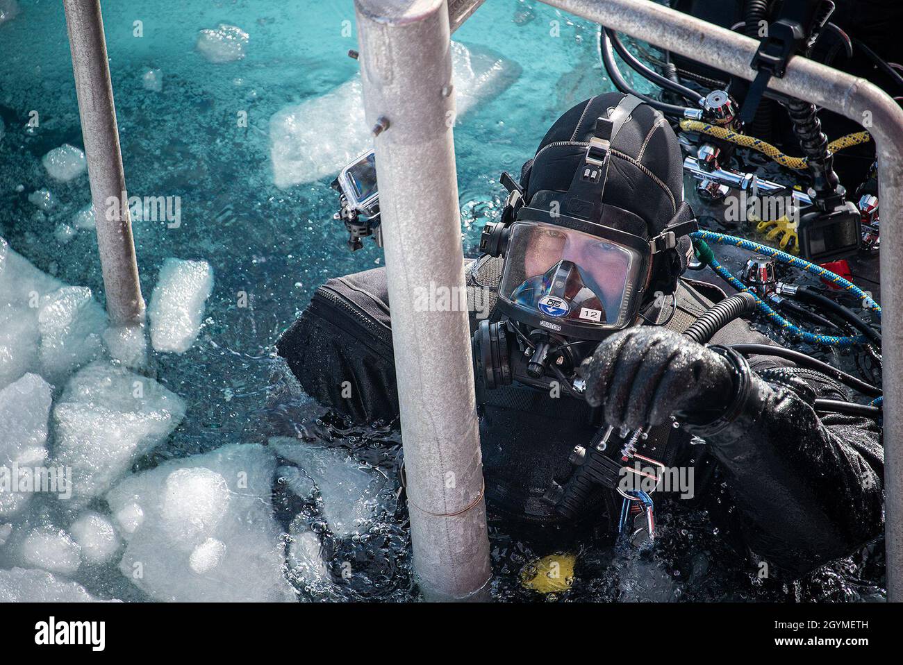 Royal Canadian Navy Leading Seaman Jeff Dubinsky uses a hand signal to ...