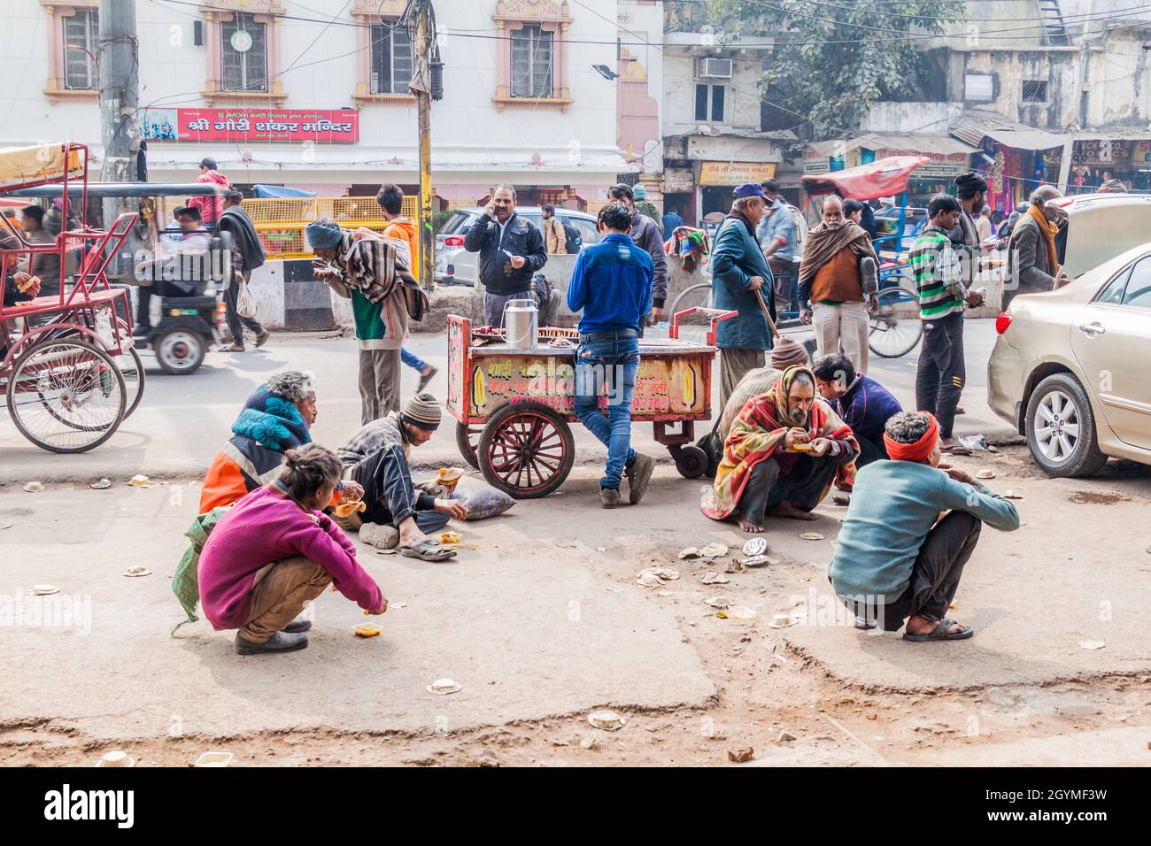 DELHI, INDIA - JANUARY 24, 2017: Local people eat on a street in Delhi ...