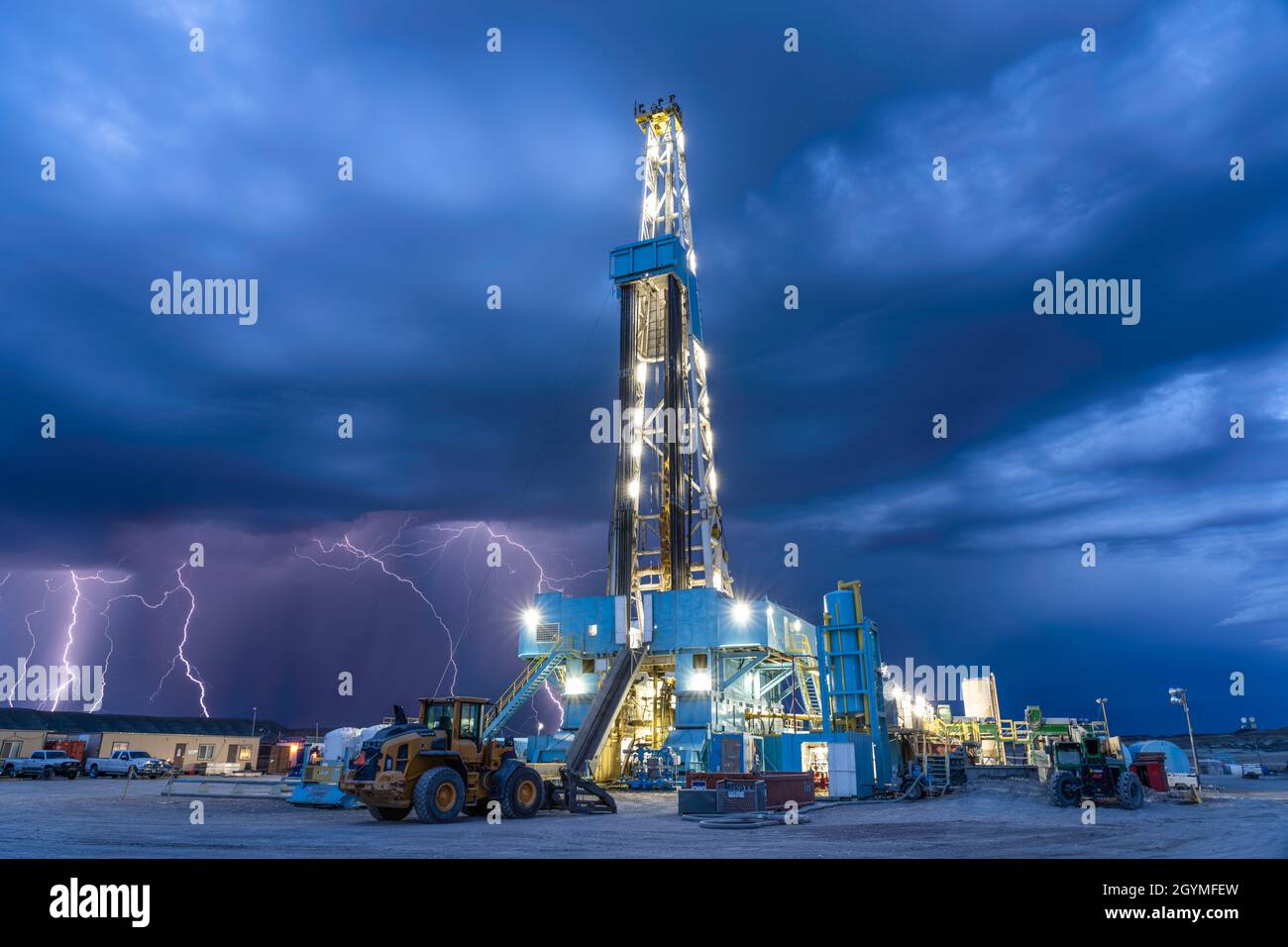 A lightning storm approaches a 3000 hp top drive drilling rig drilling ...