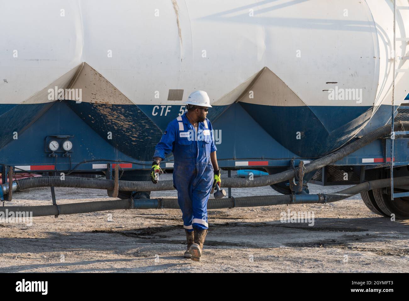 An oilfield worker and his cement truck on a drilling rig site in Utah ...