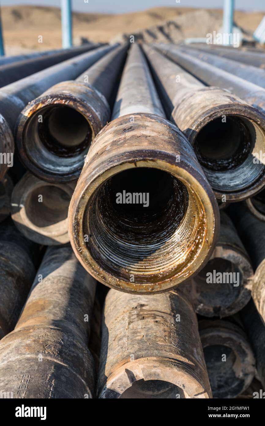 Heavy duty drill pipe on a pipe rack for drilling an oil well Stock ...