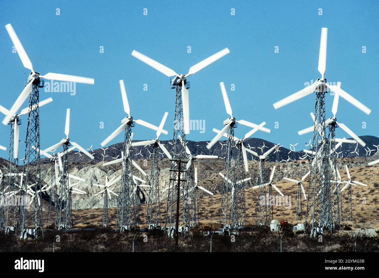 The spinning rotor blades of wind-powered electricity generators near ...