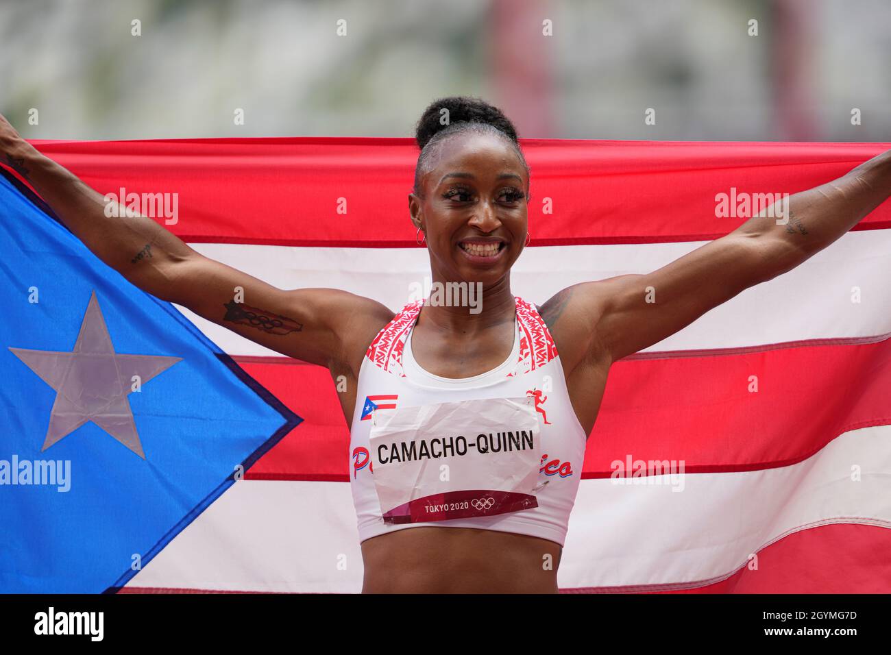 Jasmine Camacho-Quinn with her country's flag after winning gold at the ...