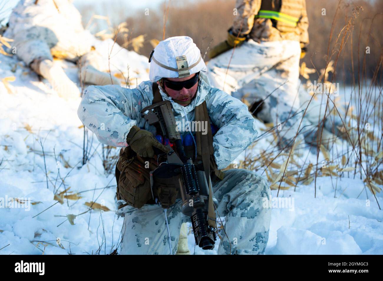 U.S. Marine from 1st Battalion, 25th Marine Regiment, reloads an M32 ...