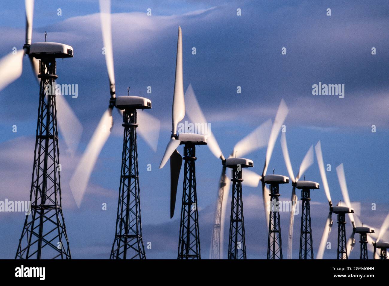 The spinning rotor blades of wind-powered electricity generators near ...