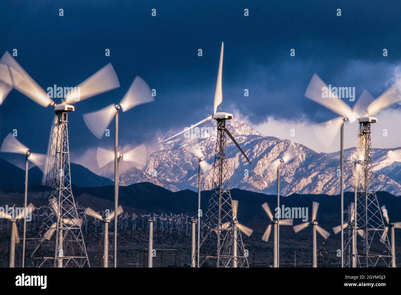 The spinning rotor blades of wind-powered electricity generators near ...
