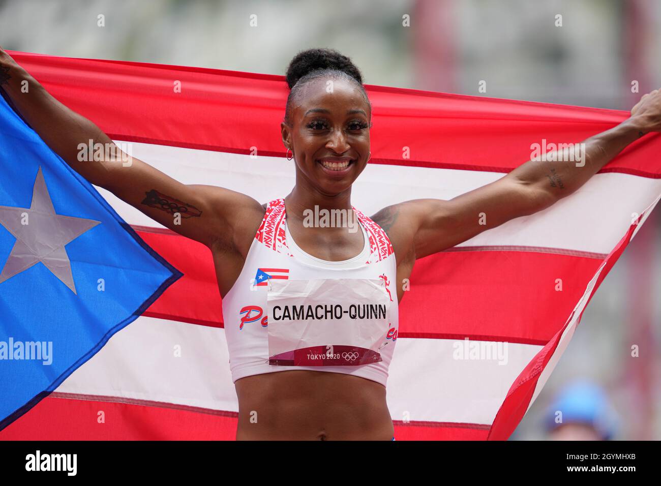 Jasmine Camacho-Quinn with her country's flag after winning gold at the ...