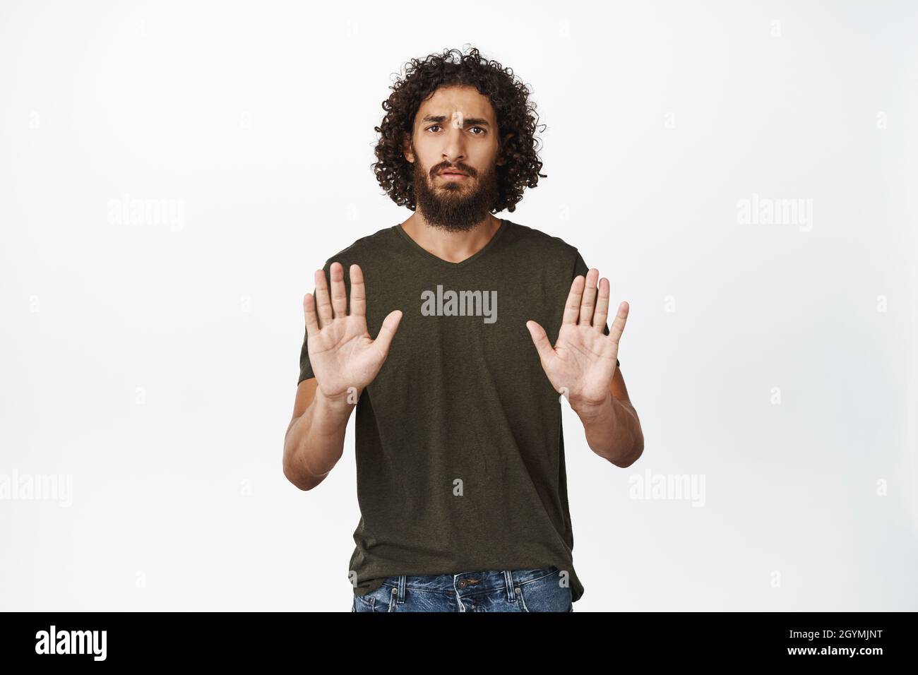 Serious looking man stretching out hand, showing stop rejection gesture ...