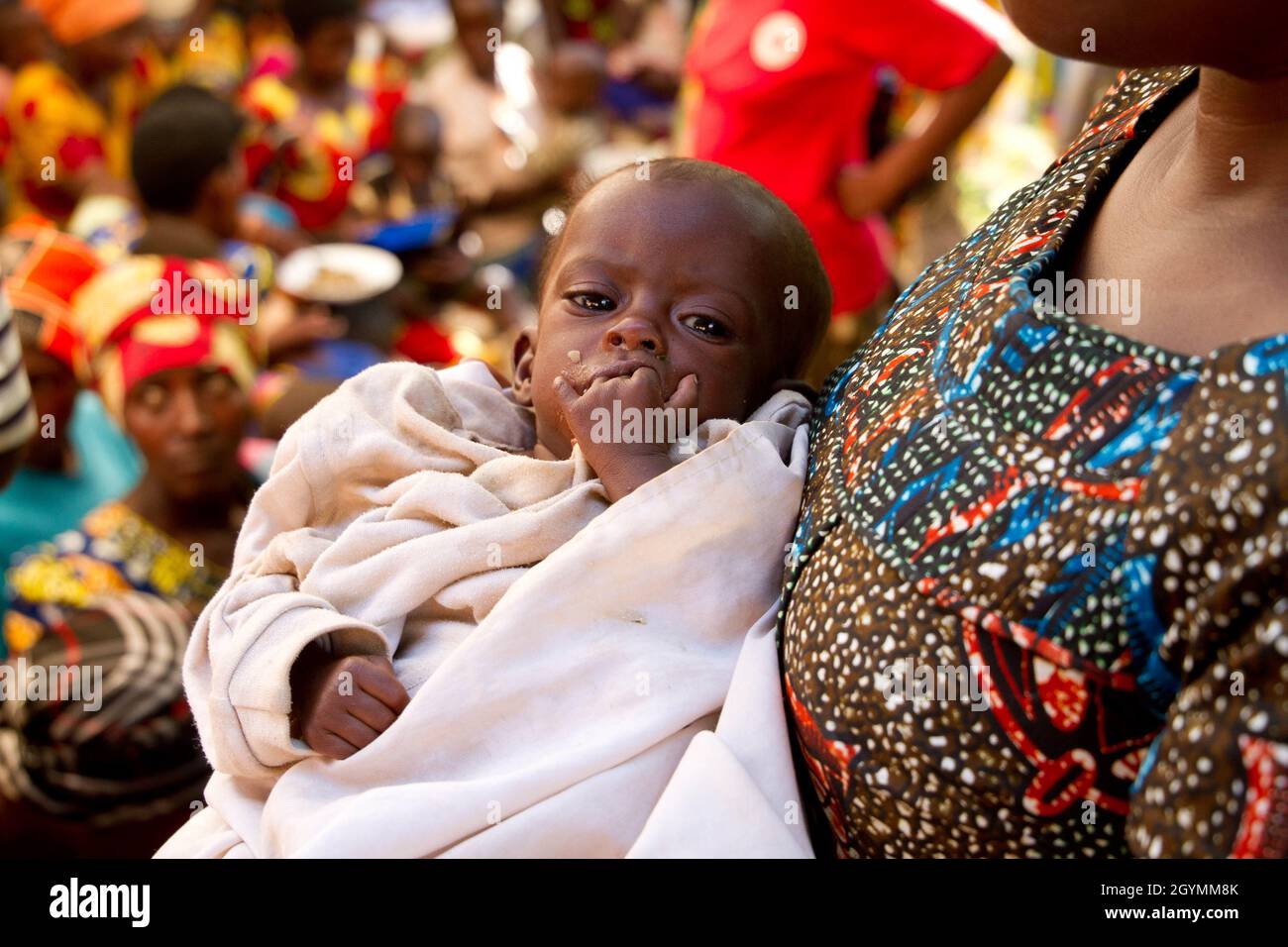 A mother carrying her baby at a function. Rwanda Stock Photo - Alamy