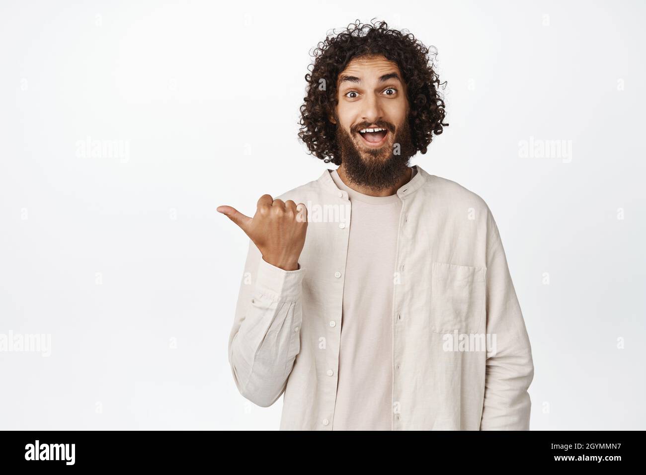 Happy adult man pointing finger left, smiling excited, showing cool ...