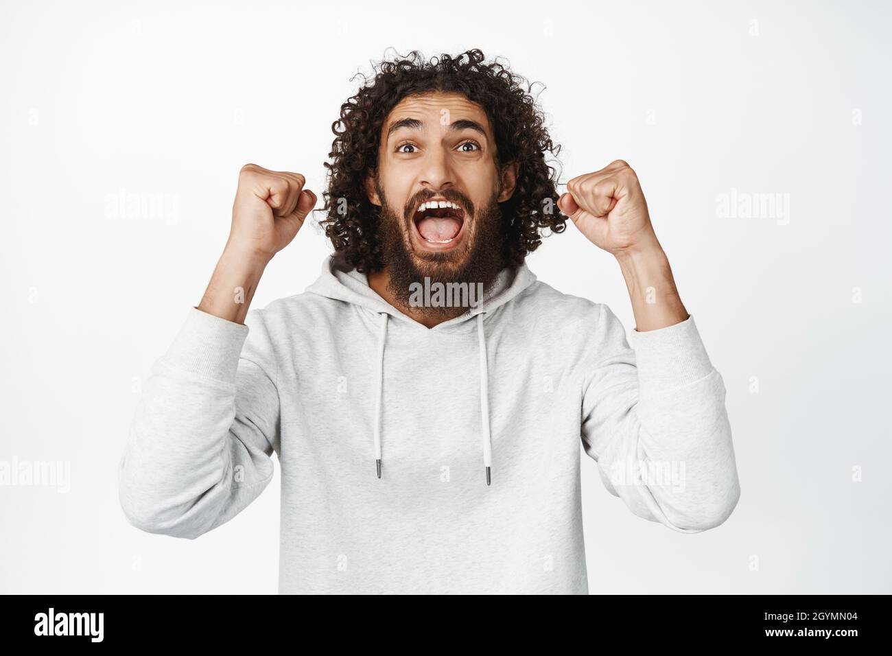 Excited sport fan, watching game, looking up and cheering, rooting for ...