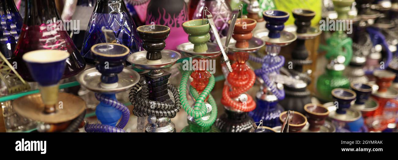Many multicolored hookahs standing on counter of store Stock Photo - Alamy