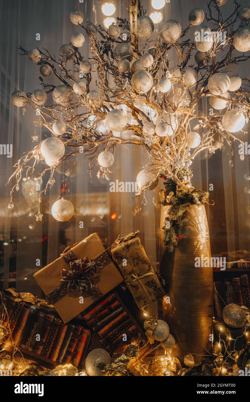 Christmas golden decorations and gift boxes with ribbons in a festive ...