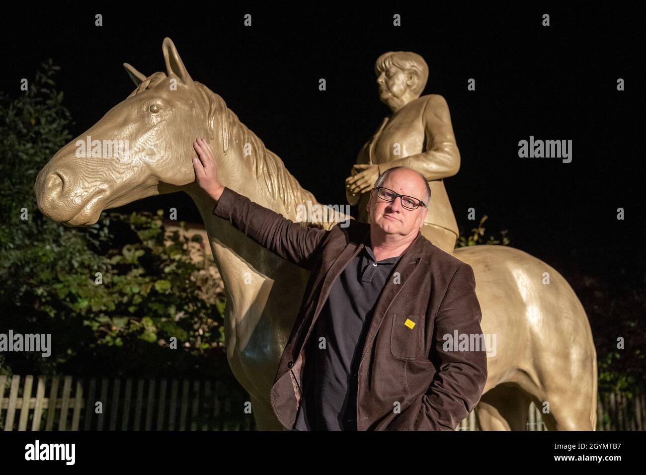 Etsdorf, Germany. 08th Oct, 2021. Artist Wilhelm Koch stands next to an ...