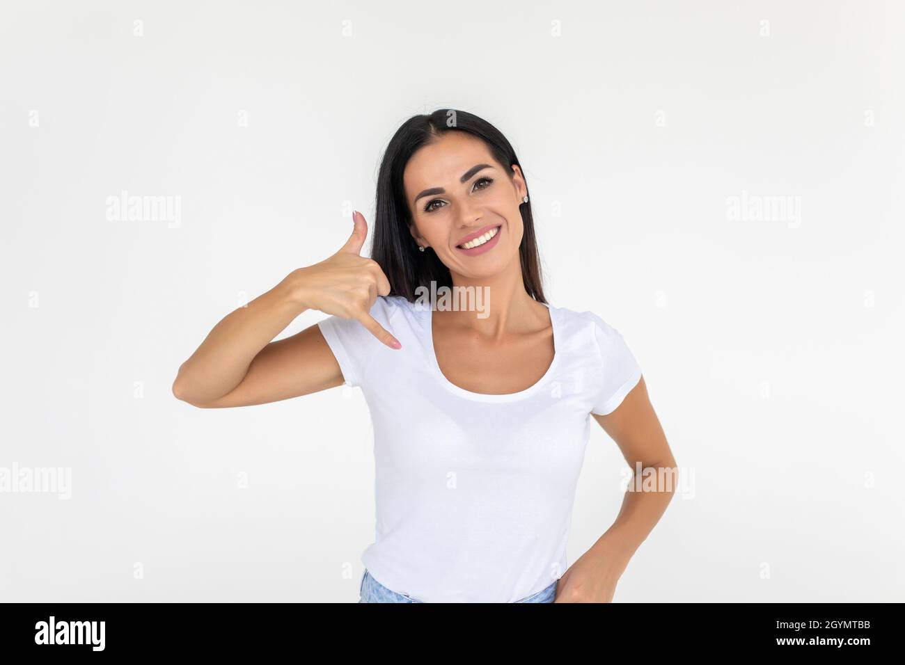 Young woman with calling sign on white background Stock Photo - Alamy