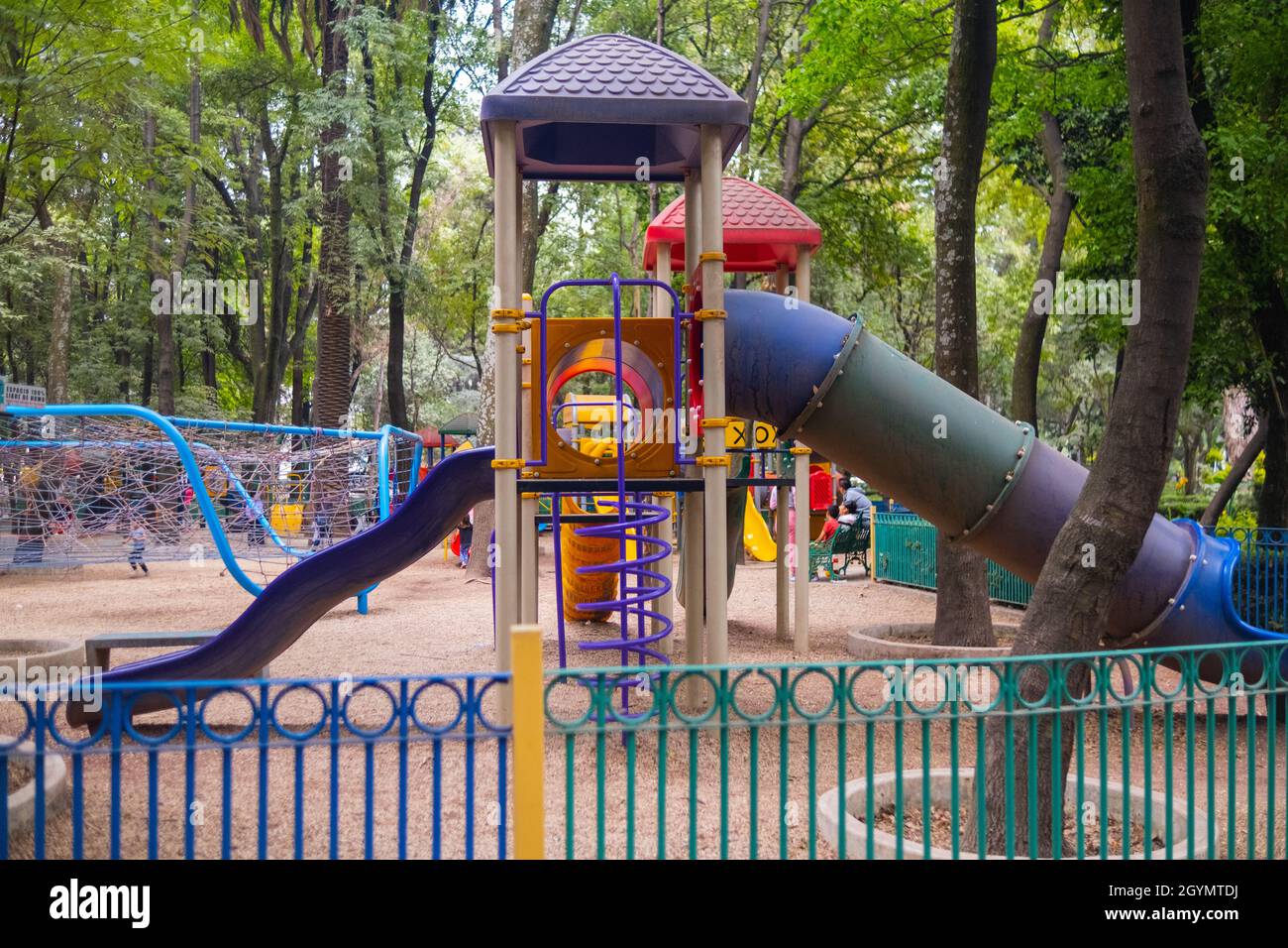 Colorful playground slide in the middle of a park Stock Photo - Alamy