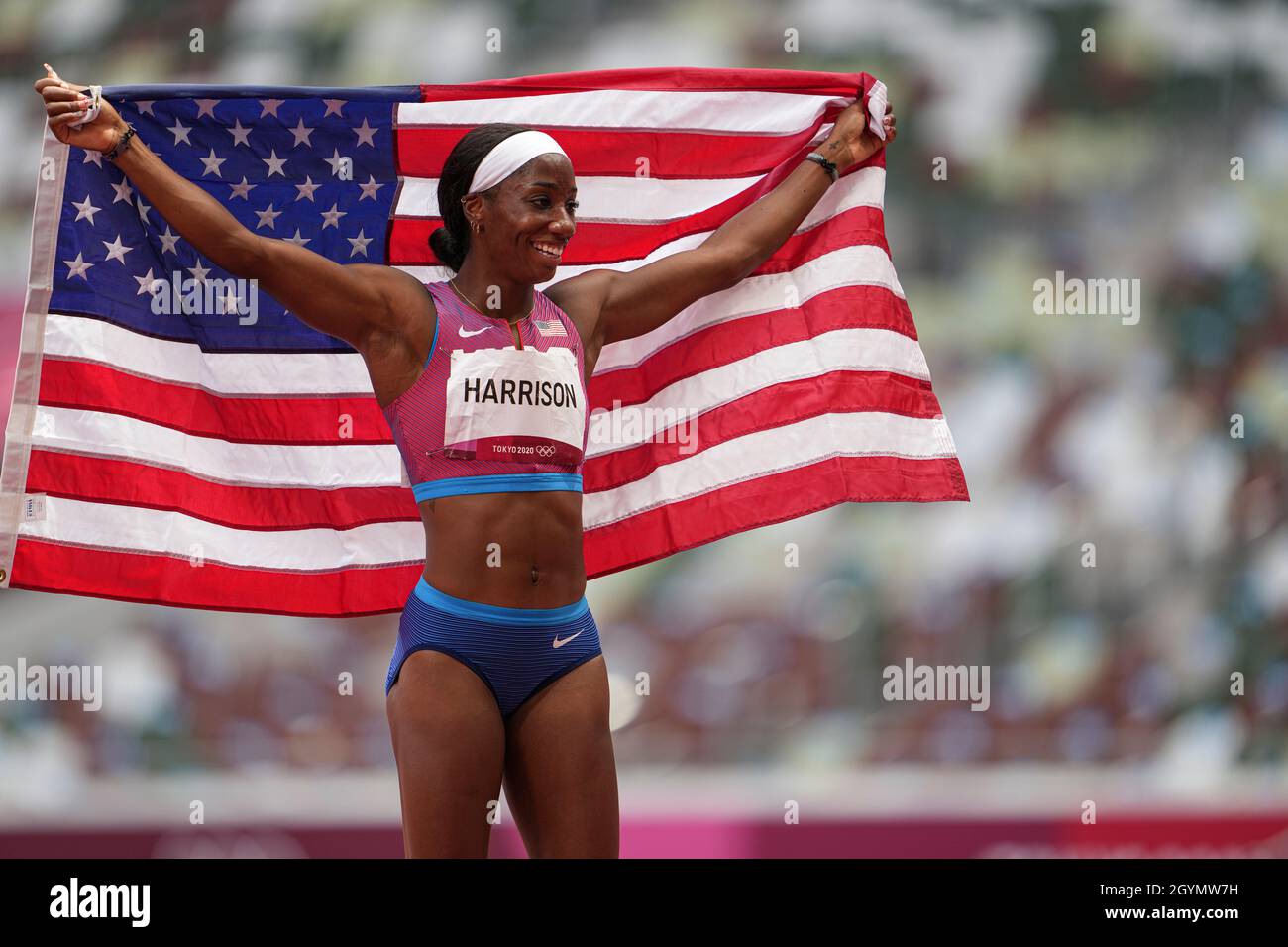 Keni Harrison with her country's flag after winning the silver medal at ...