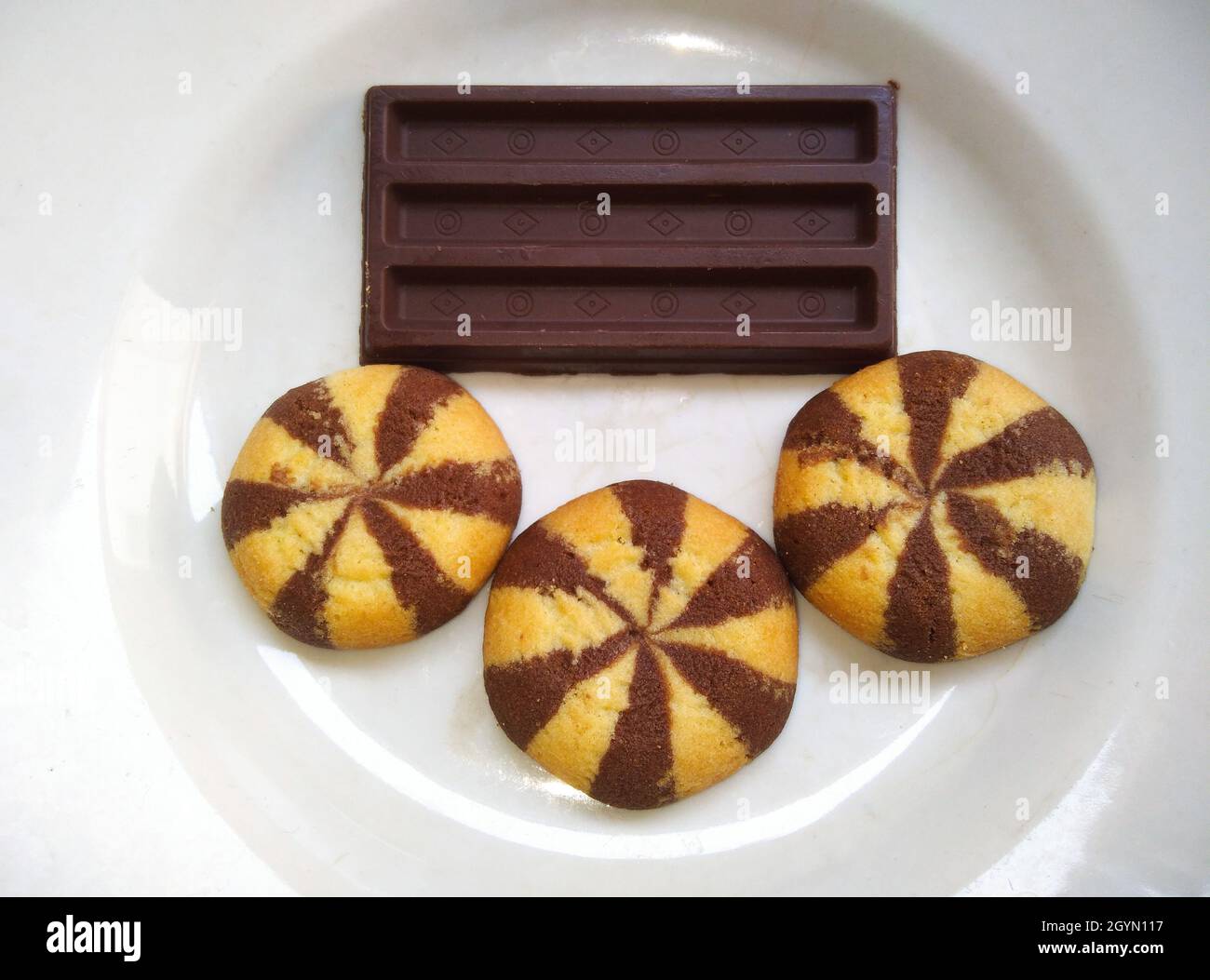 Top view closeup of three striped chocolate biscuits and a chocolate ...