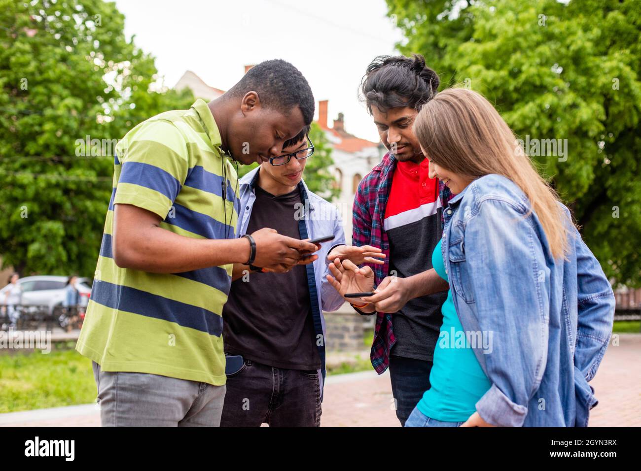 Multiethnic university students checking information using mobile ...