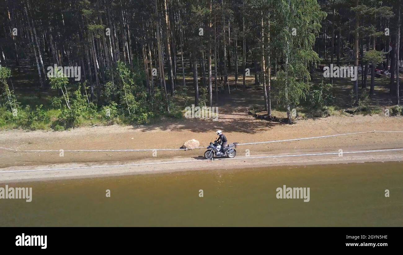 Motorcyclist riding alone in woods. Clip. Aerial view. Motorcycle ...