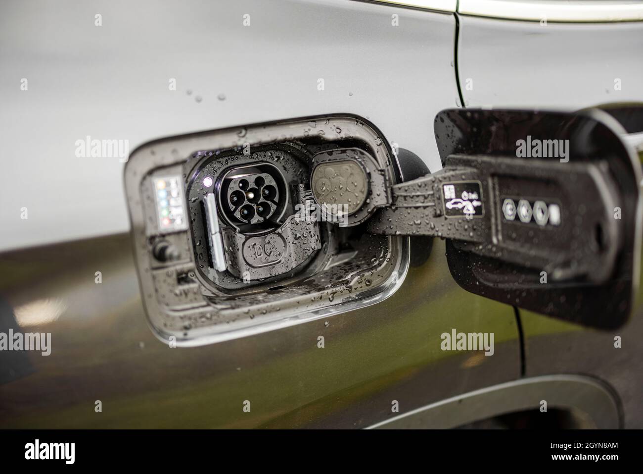 Close up view of an open hatch in an electric car for charging it ...