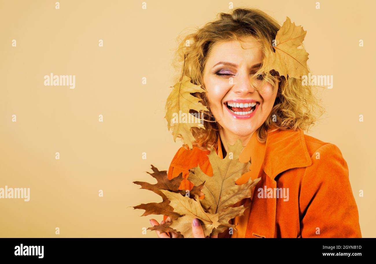 Happy young girl with autumn leaf. Fashion trends for fall. Autumn ...