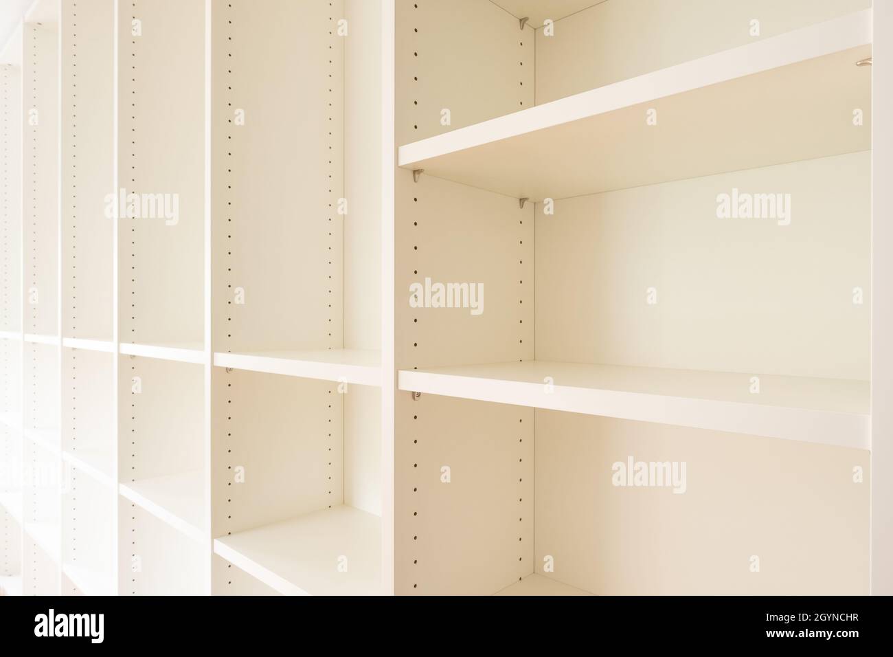 Closeup of empty white racks of furniture Stock Photo - Alamy