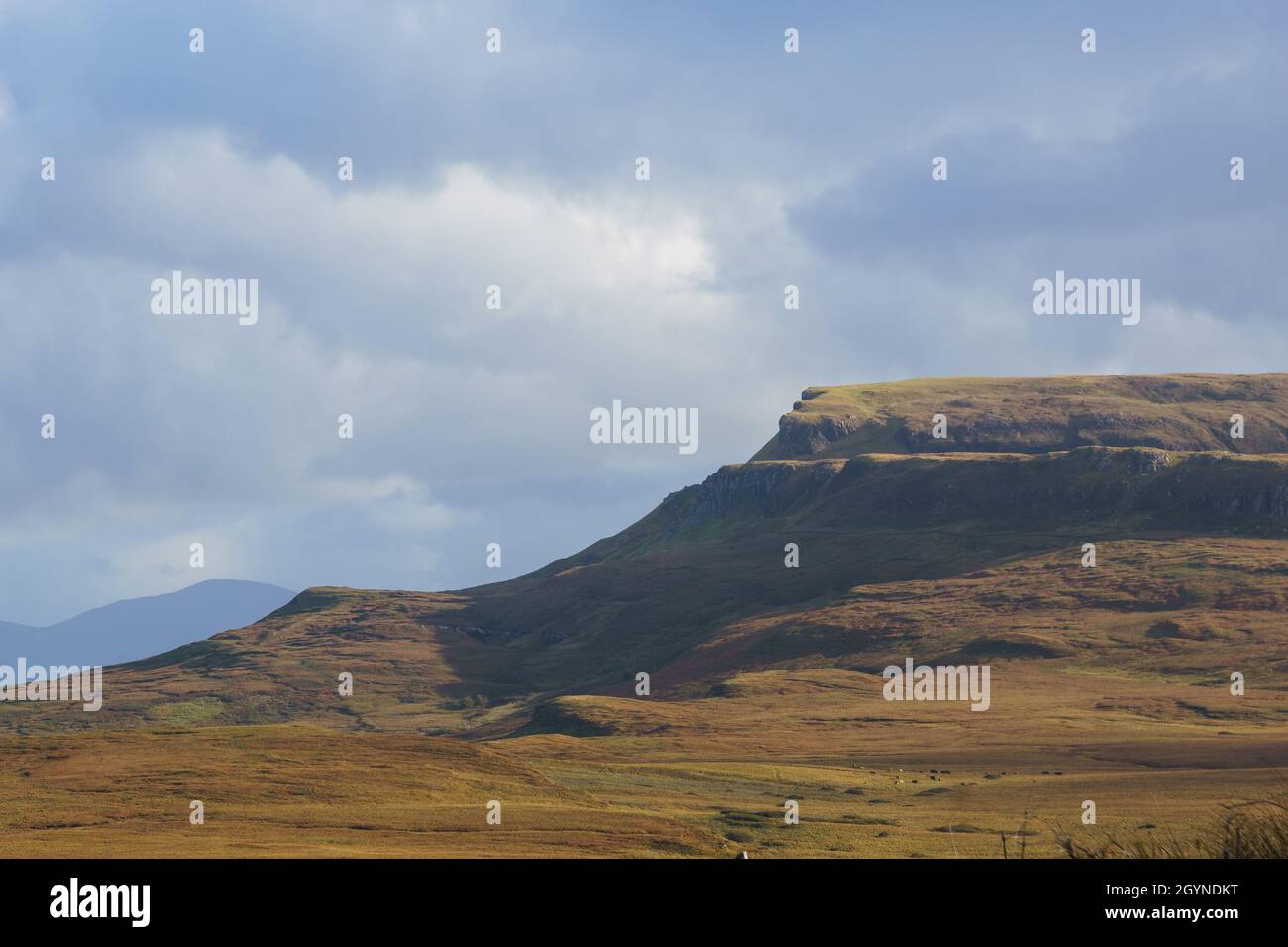 Rock formation under a cloudy sky at golden hour at Isle of Skye ...
