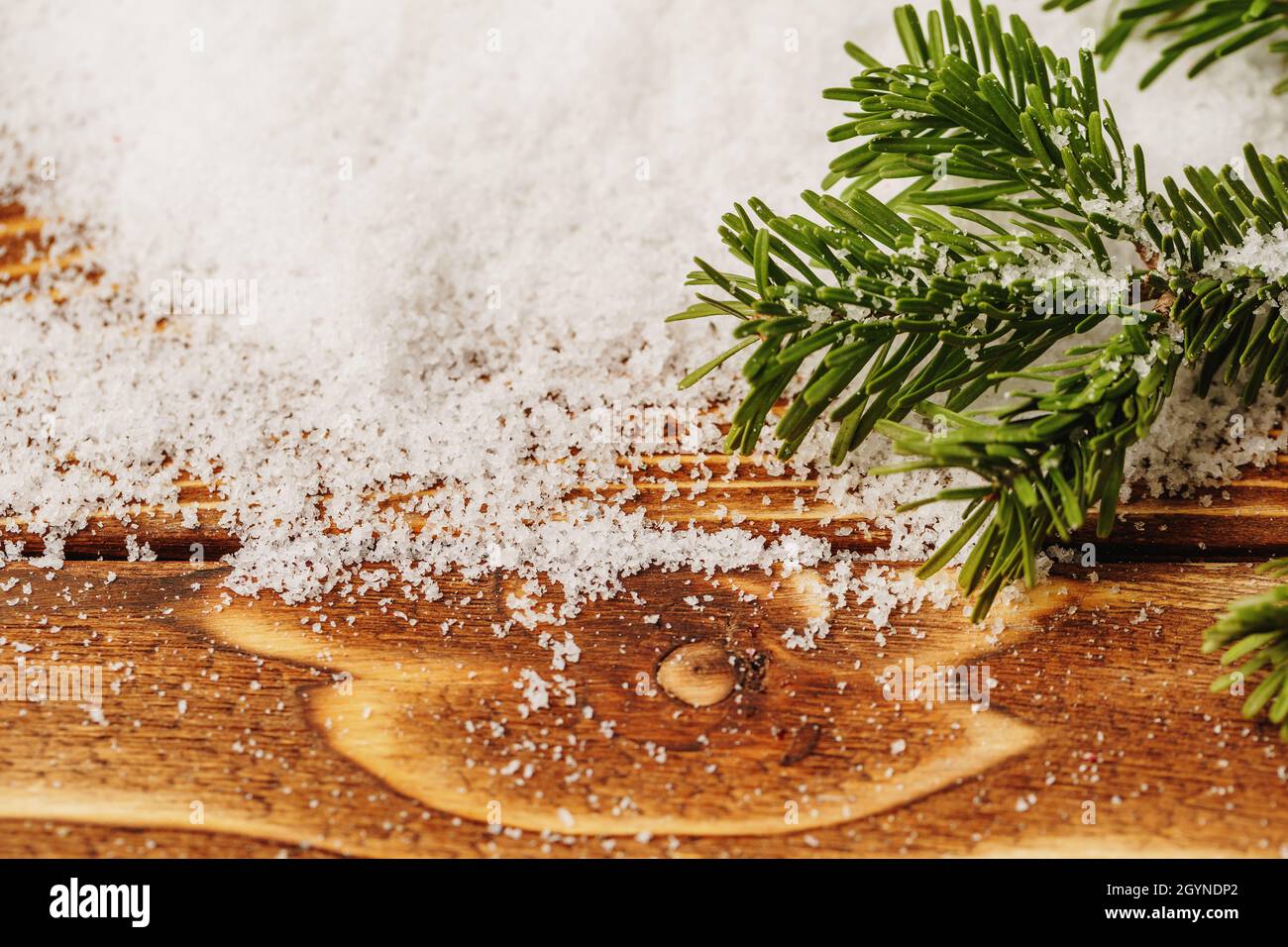Wooden table with snow on it close up Stock Photo - Alamy