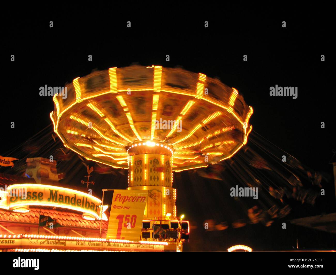 Spinning carousel in an entertainment park at night Stock Photo - Alamy