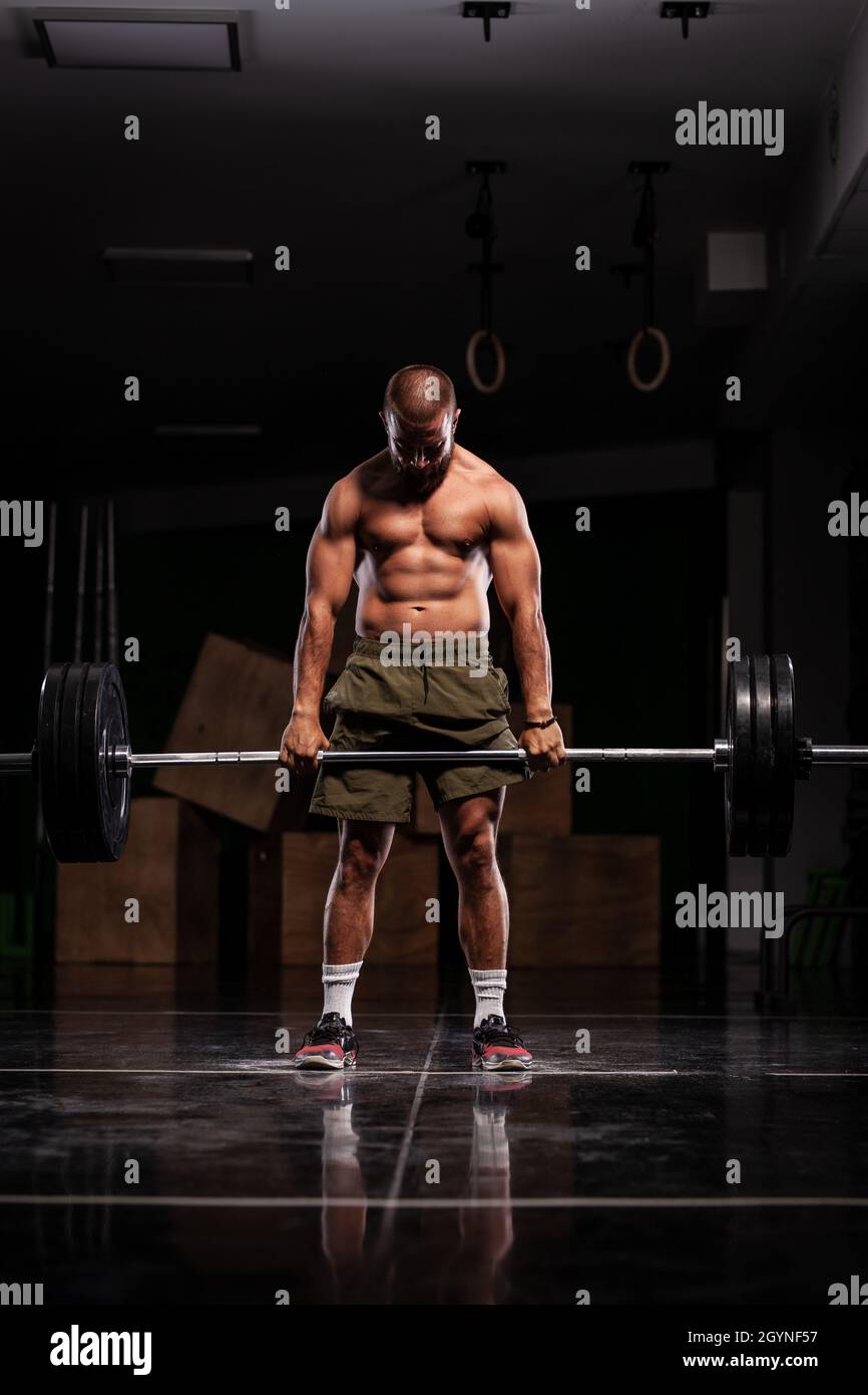 Muscular athlete lifting very heavy barbell Stock Photo - Alamy
