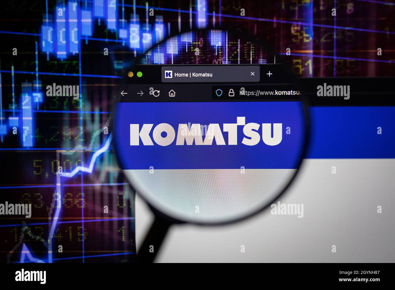 Komatsu company logo on a website with blurry stock market developments ...
