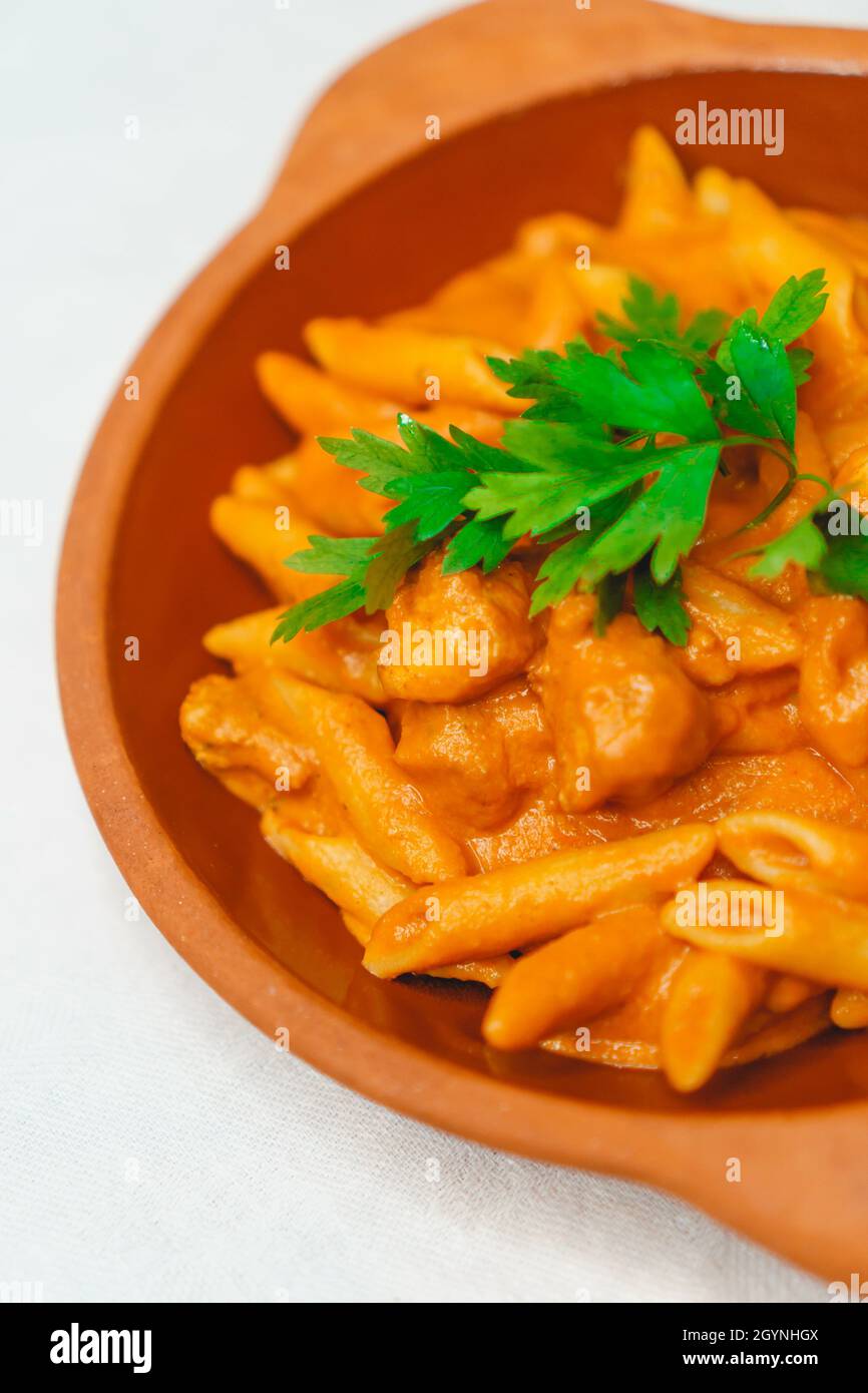 Vertical high angle shot of a spicy Indian Red pasta with white ...