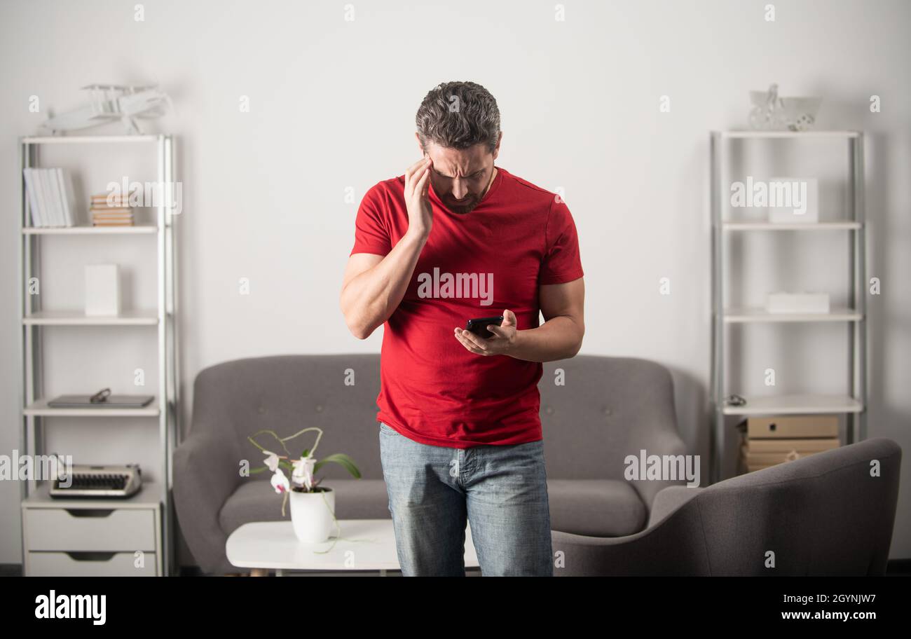 unhappy adult man check text message in smartphone, communication Stock ...