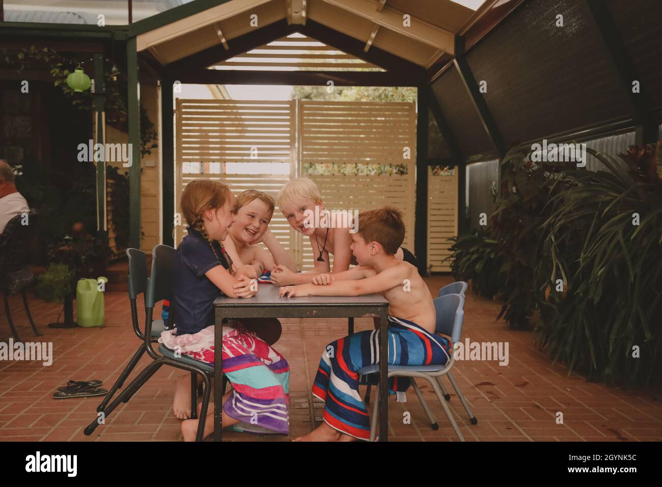 Group of children sitting together at outdoor table at family get ...