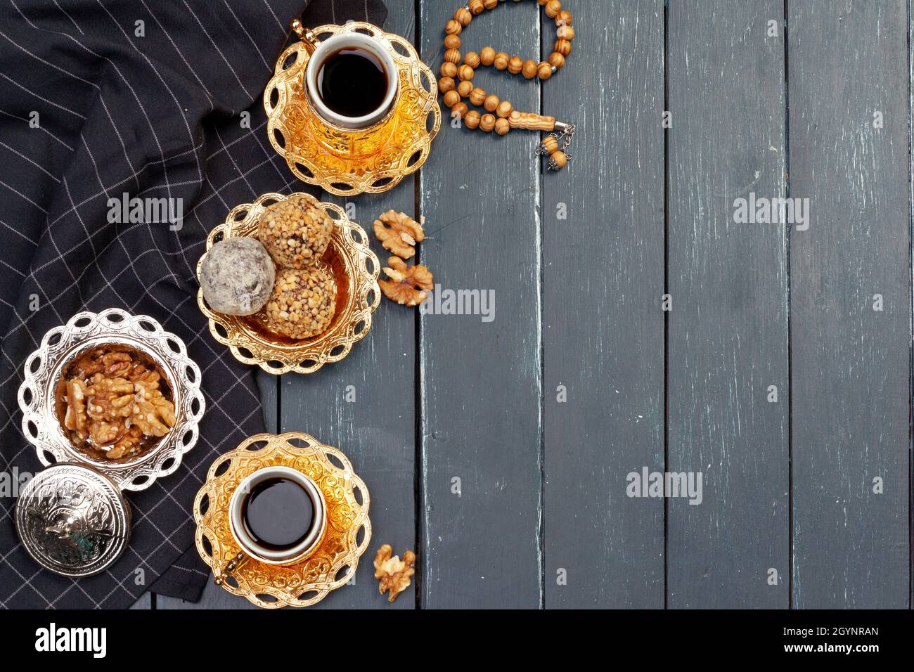 Nut balls dessert served with coffee on dark wooden table, top view ...