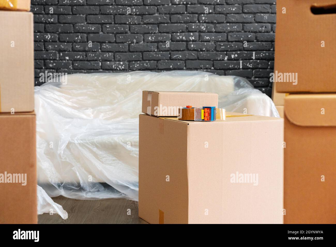 Moving in or moving out concept. Stack of boxes and packed furniture ...