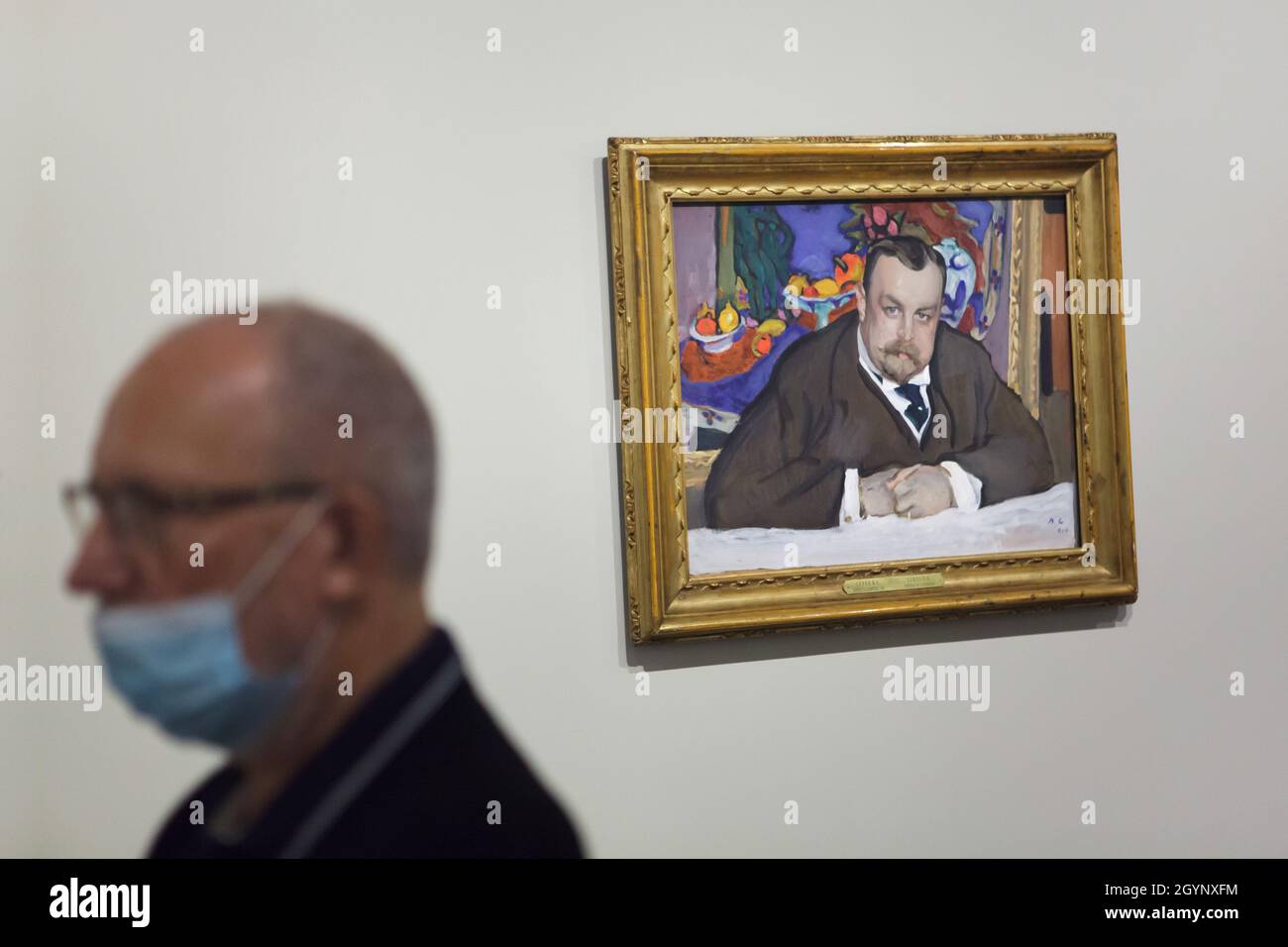 Visitor wearing a face mask in front of the tempera painting 'Portrait ...