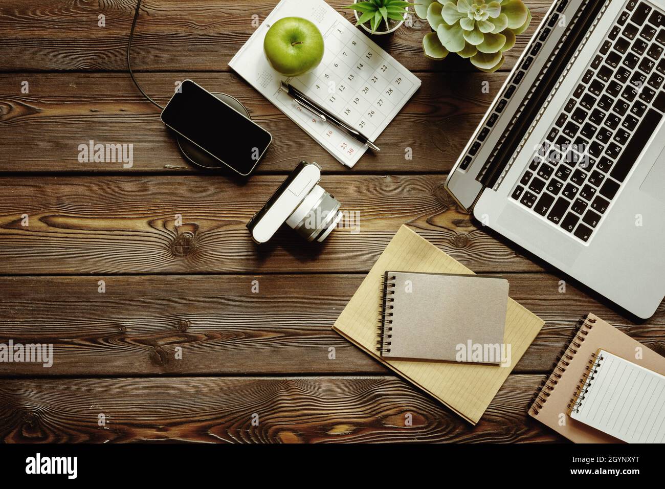 Dark wooden table with laptop, notepad top view Stock Photo - Alamy