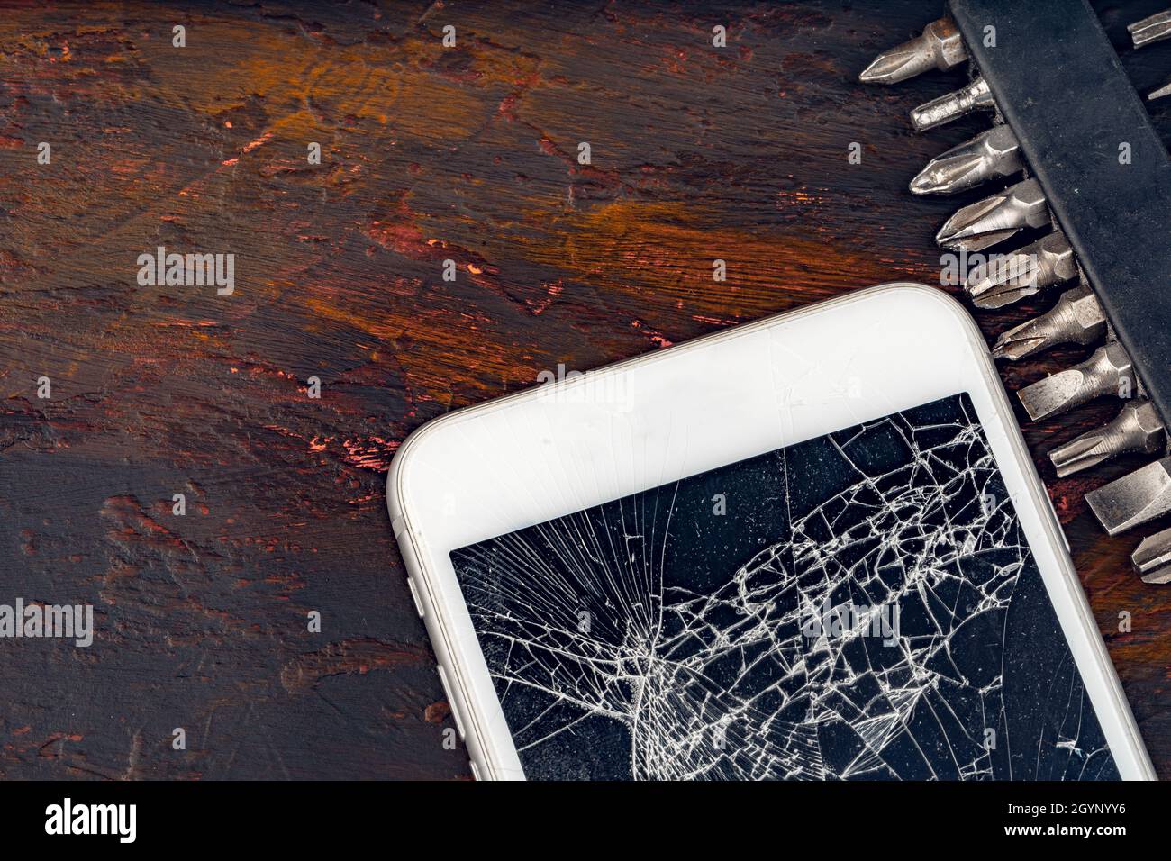 Smartphone repair concept. Damaged display of smartphone and tools ...