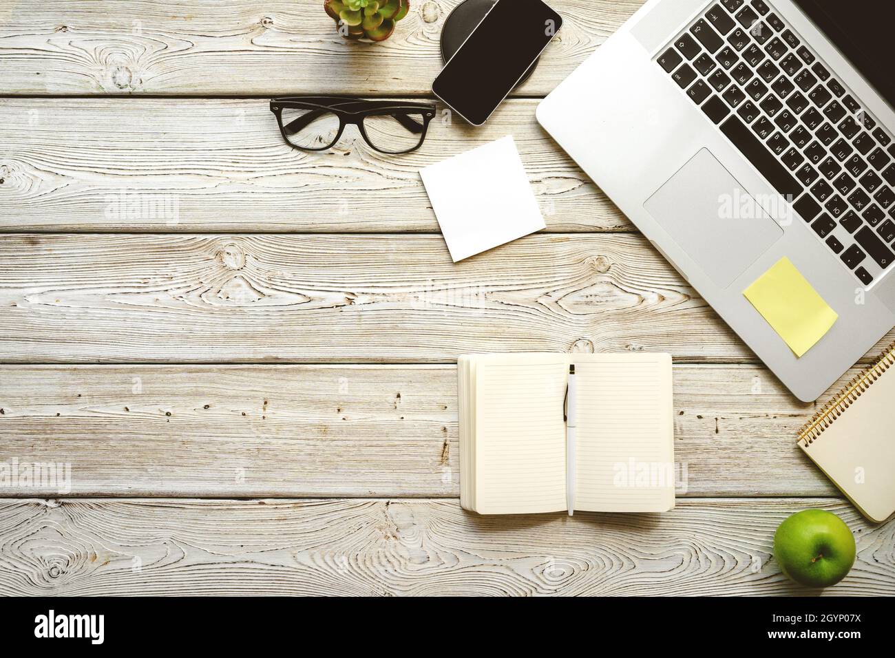 Office table workspace top view. Wooden desk with laptop, devices and ...