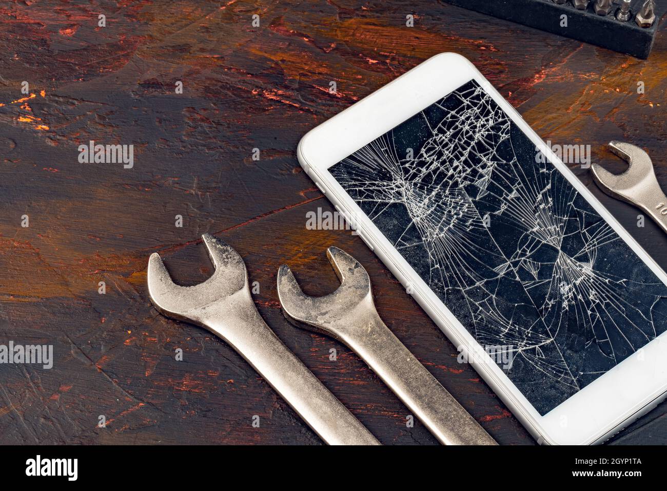 Smartphone repair concept. Damaged display of smartphone and tools ...