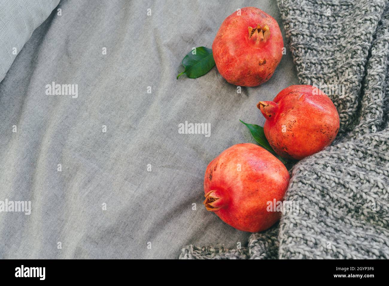 Pomegranate on a gray plaid close up Stock Photo - Alamy