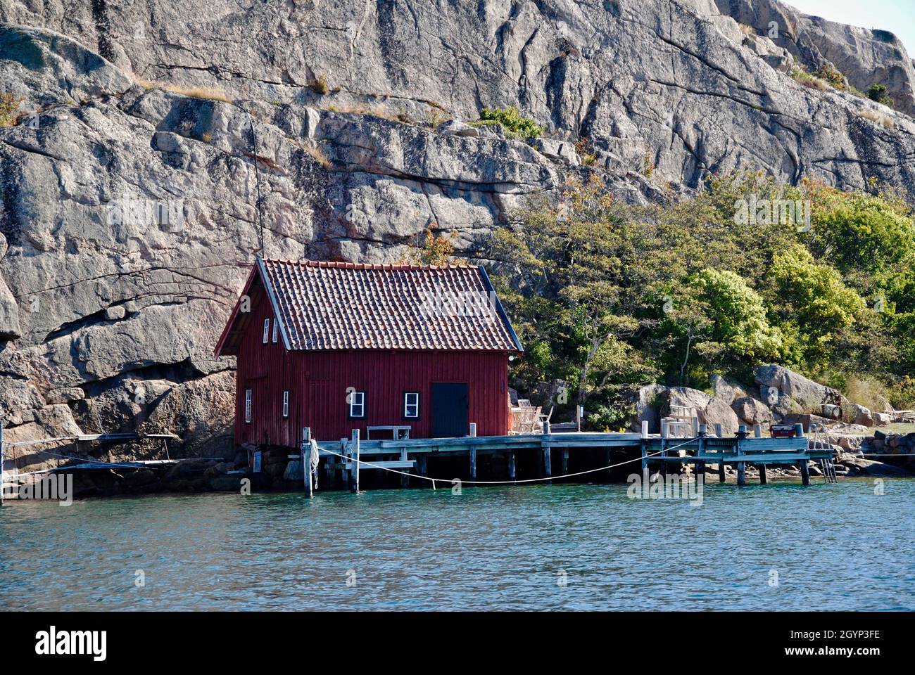 Fishermans cottage by cliffside on island in Fjällbacka archipelago on ...