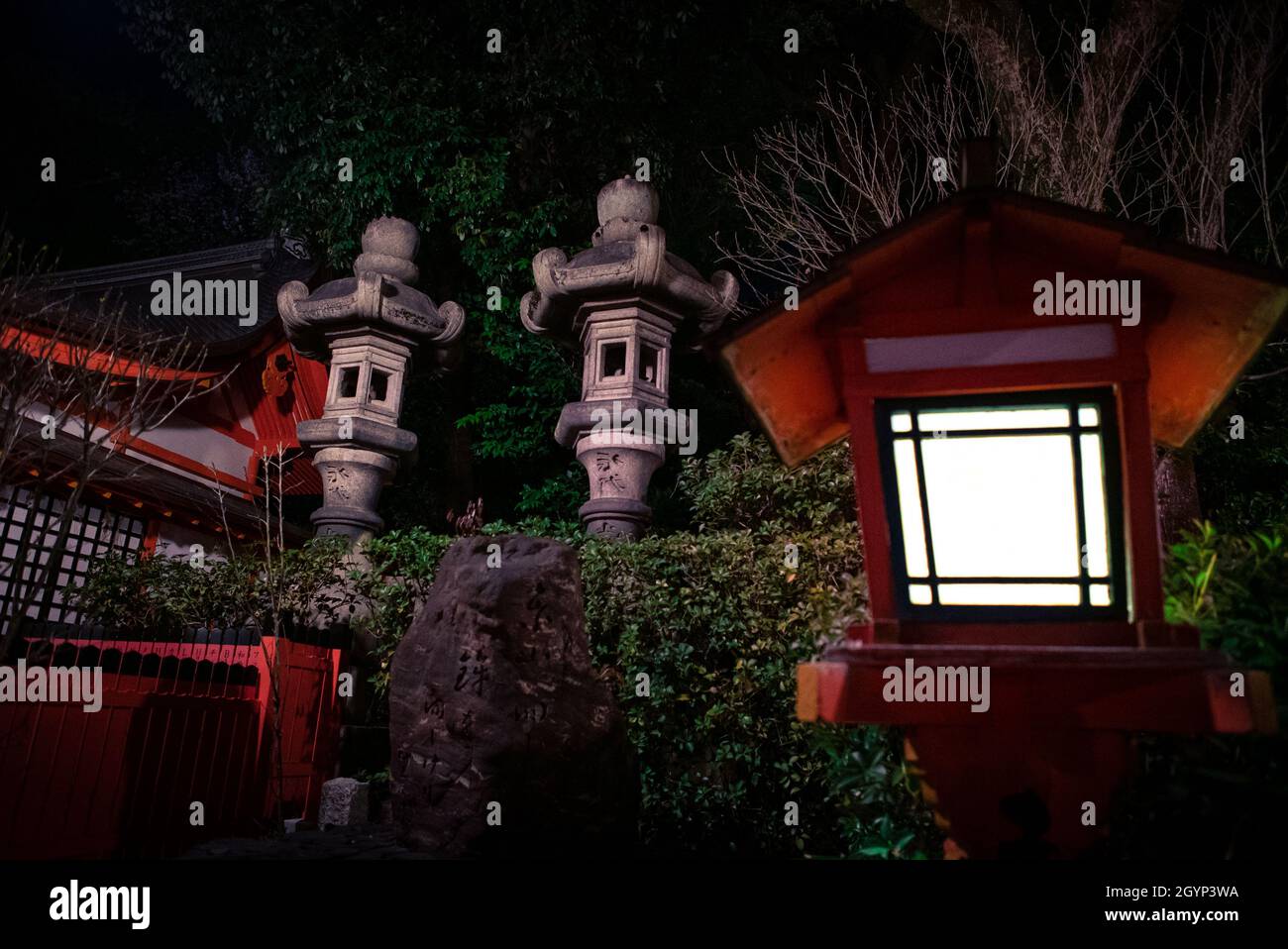 Traditional red Japanese lantern posts in Yasaka Shrine at night. Gion ...