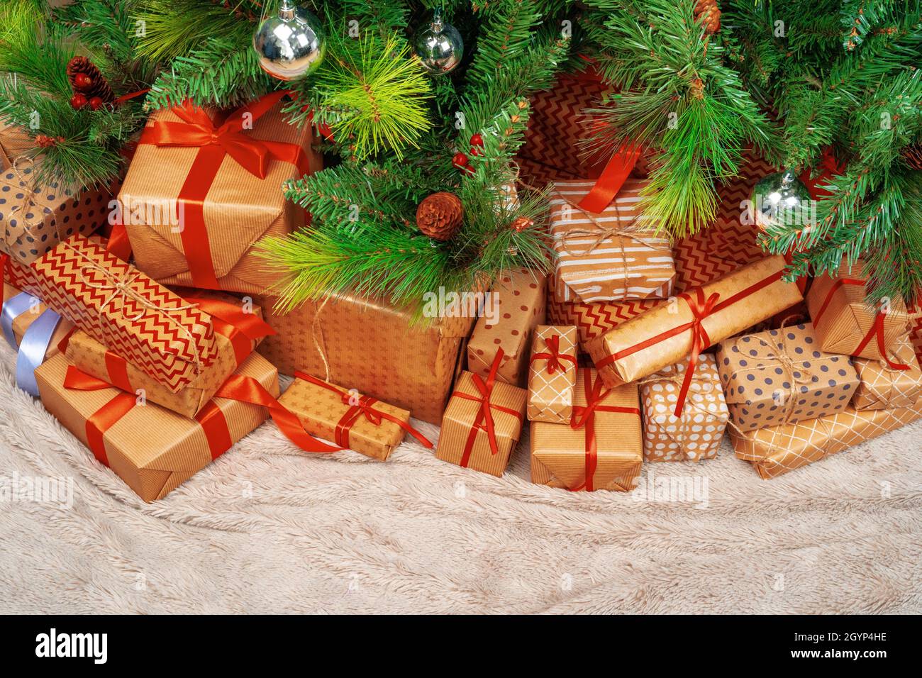 Stack of wrapped presents under Christmas tree Stock Photo - Alamy