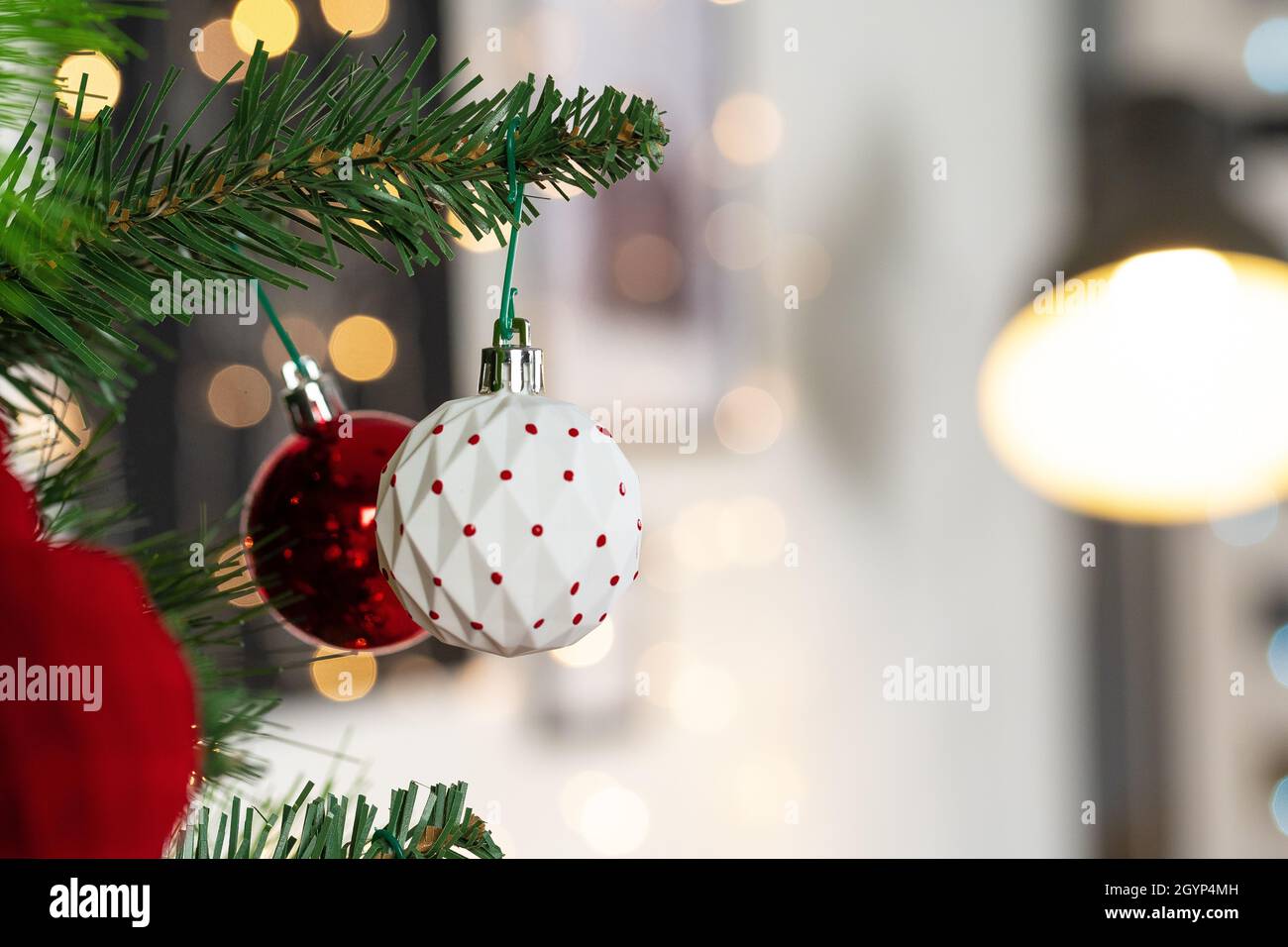 Red and white baubles hanging from a Christmas tree close up Stock ...