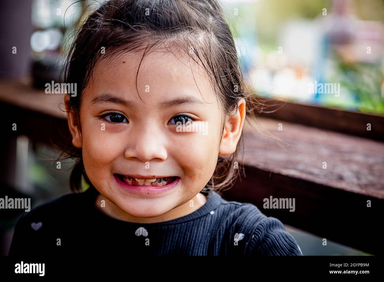 A small Vietnamese girl is very happy and smiling at coffee shop Stock ...